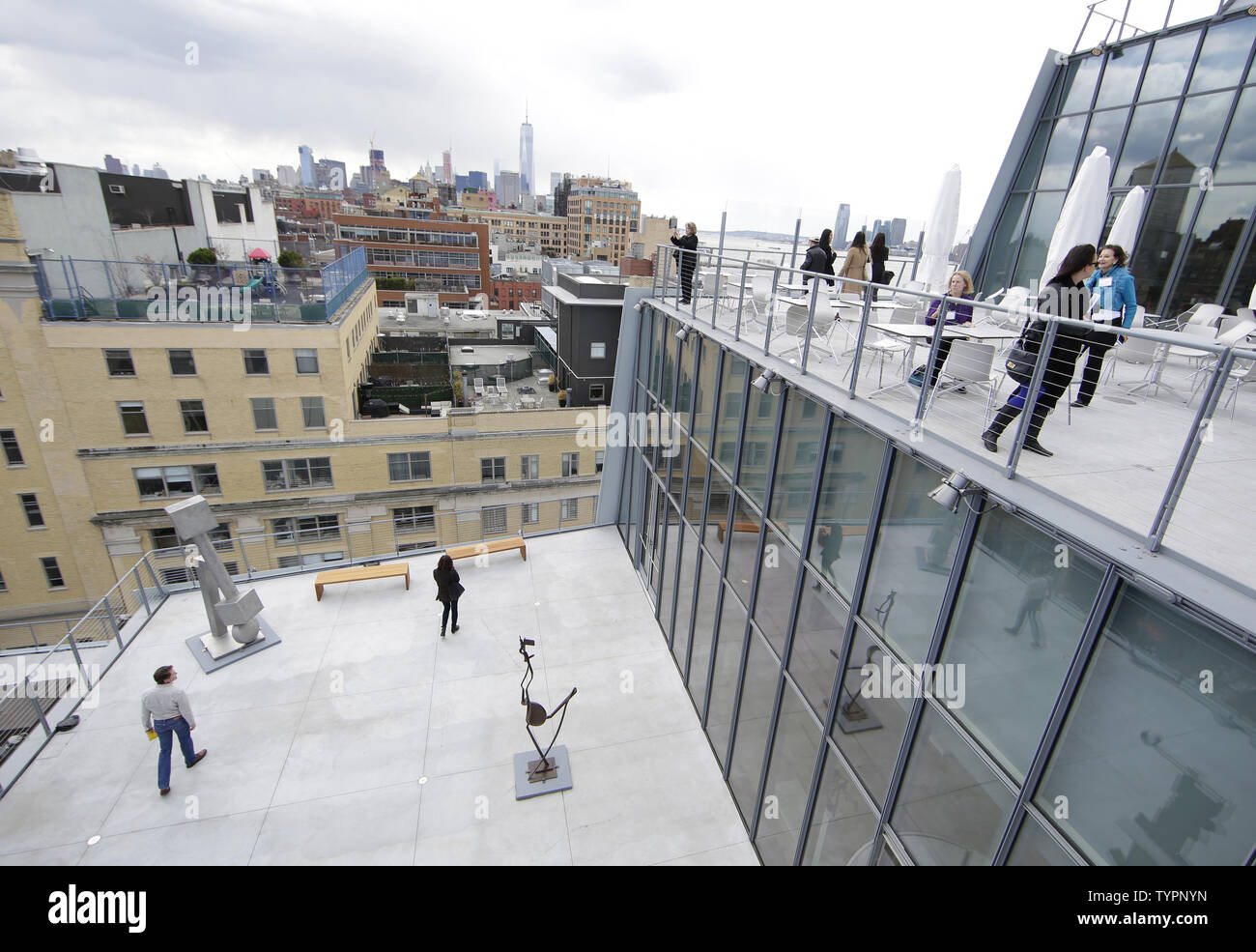 People walk on the outdoor patios and balcony's while touring through ...