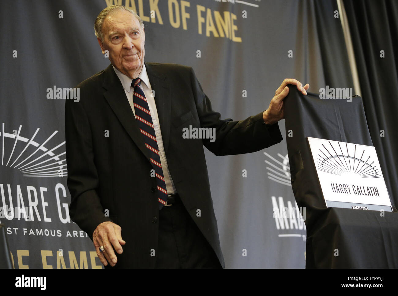 Harry Gallatin stands on stage after his induction speech at the ...