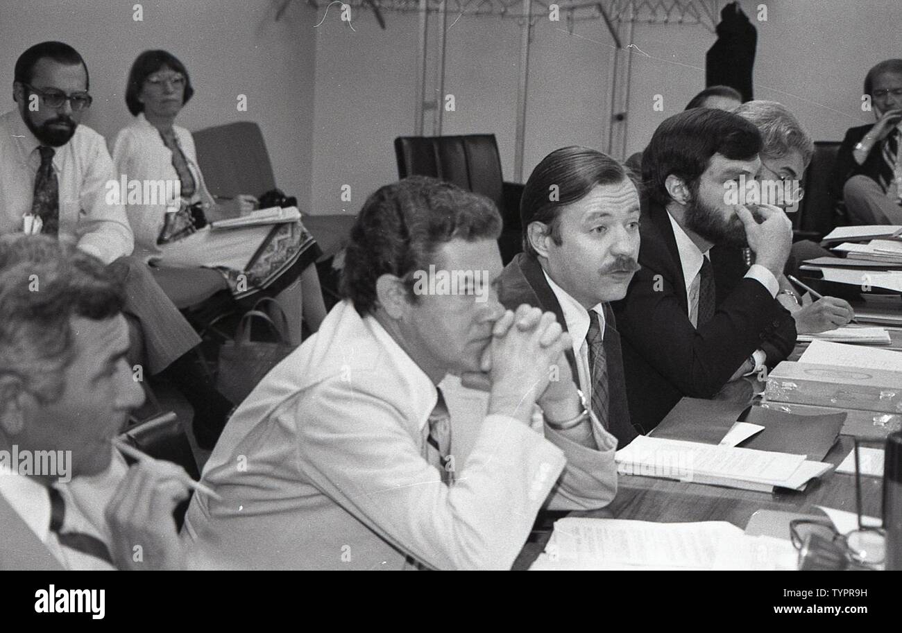 MEN SITTING GATHERED AROUND A TABLE, HAVING A MEETING. 4-12-78 LA ...