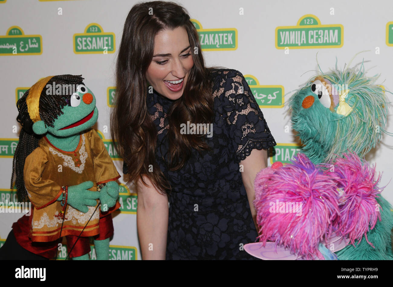 Sara Bareilles stands on the red carpet with Sesame Street Muppet's at ...