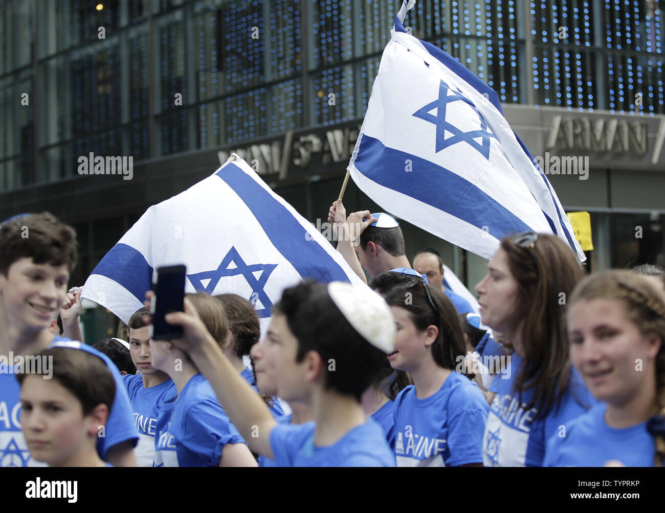 Participants march up Fifth Avenue carrying Israeli Flags and balloons ...