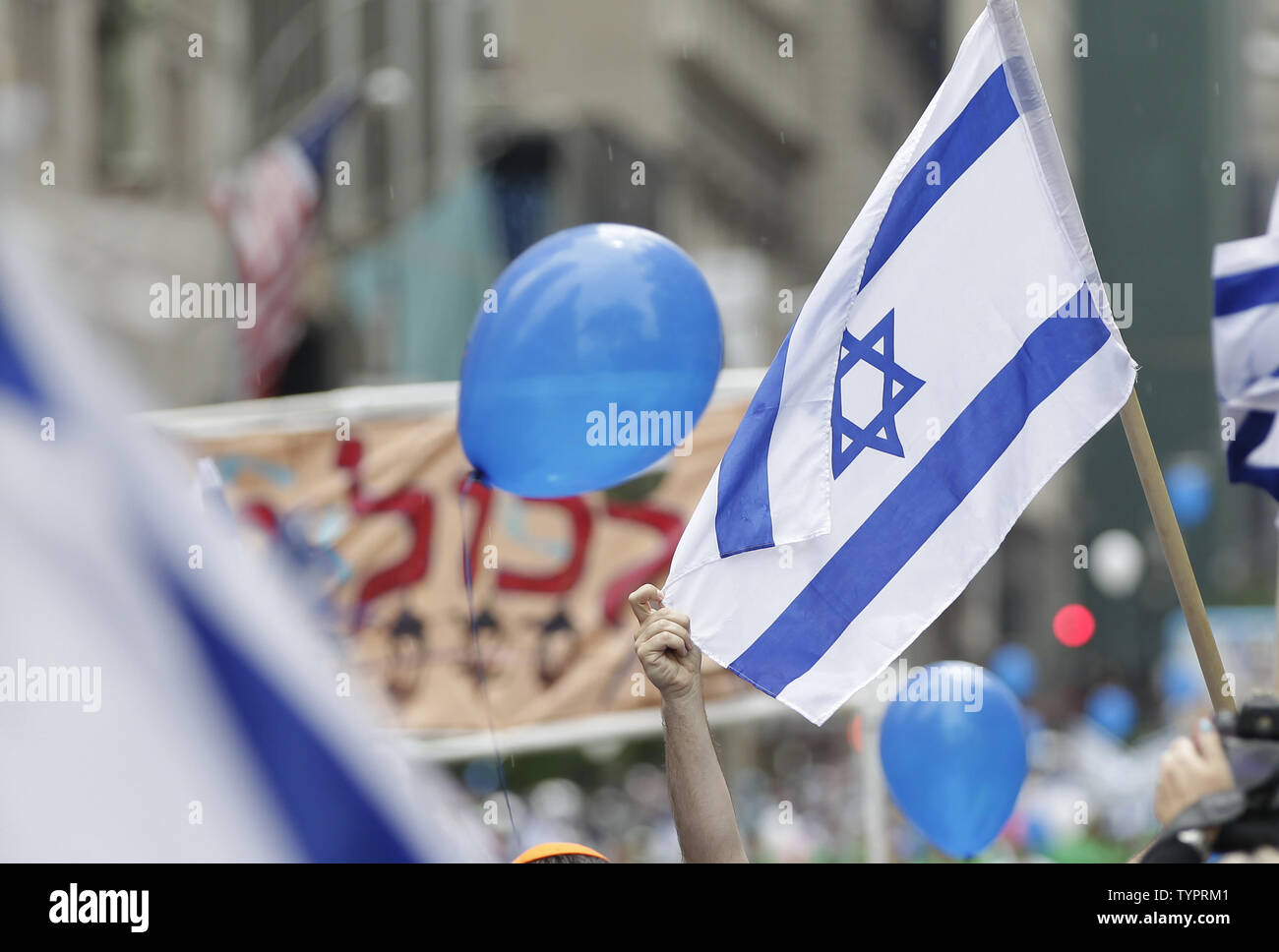Participants march up Fifth Avenue carrying Israeli Flags and balloons ...