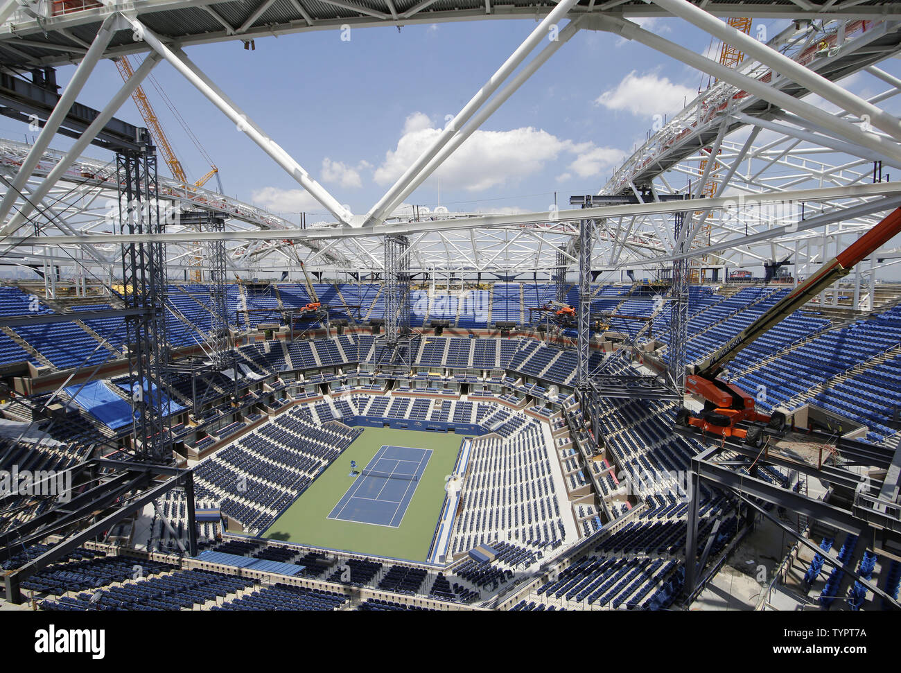 Construction workers work in Arthur Ashe Stadium after the final beam ...