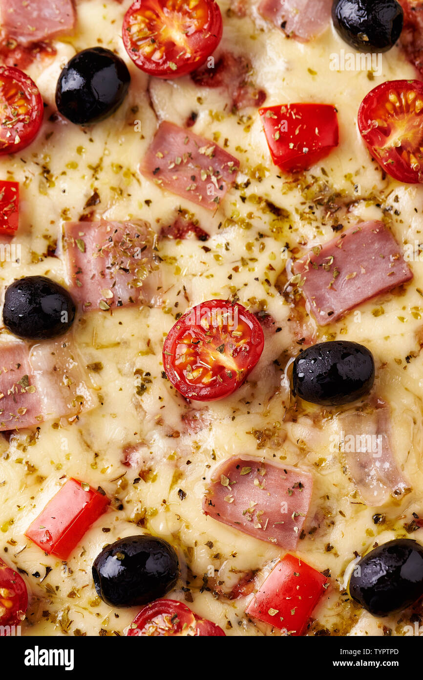 Pizza with ham, mozzarella cheese, cherry tomatoes, red pepper, black ...