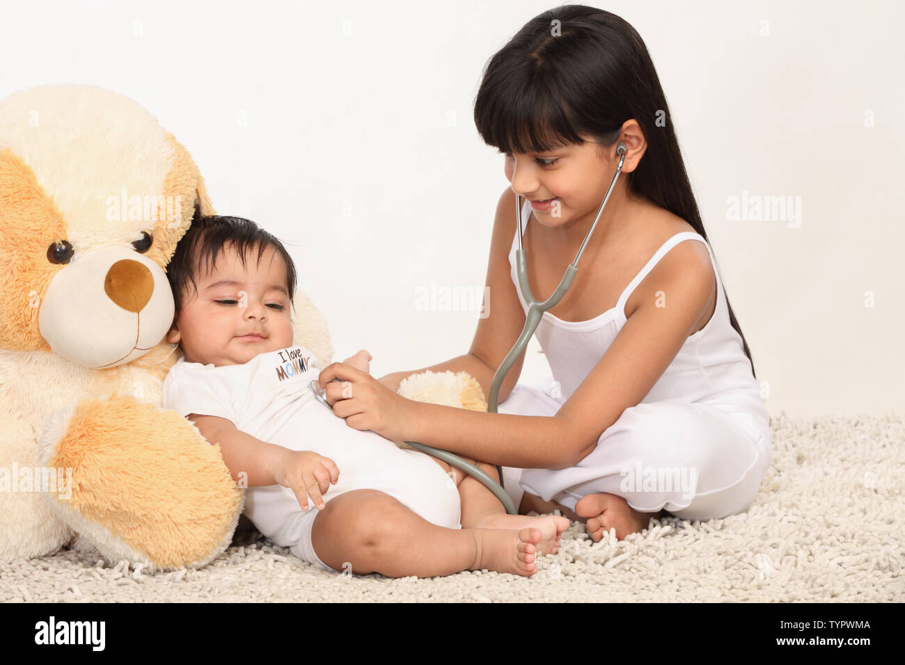 Indian girl examining her brother with stethoscope Stock Photo - Alamy