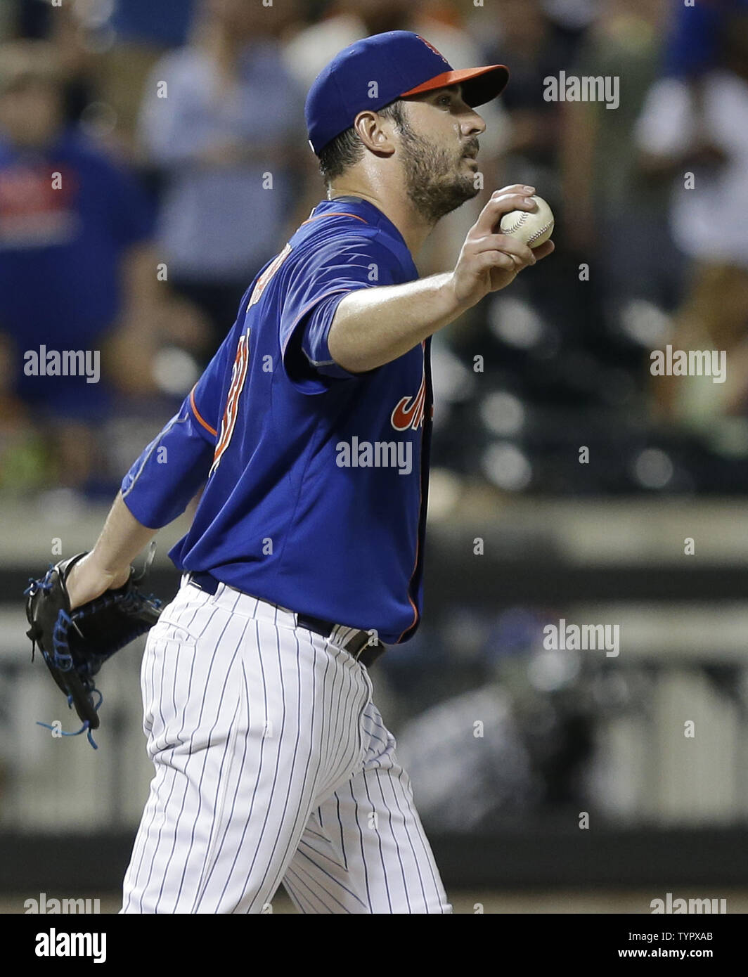 New York Mets starting pitcher Matt Harvey walks back to the mound ...
