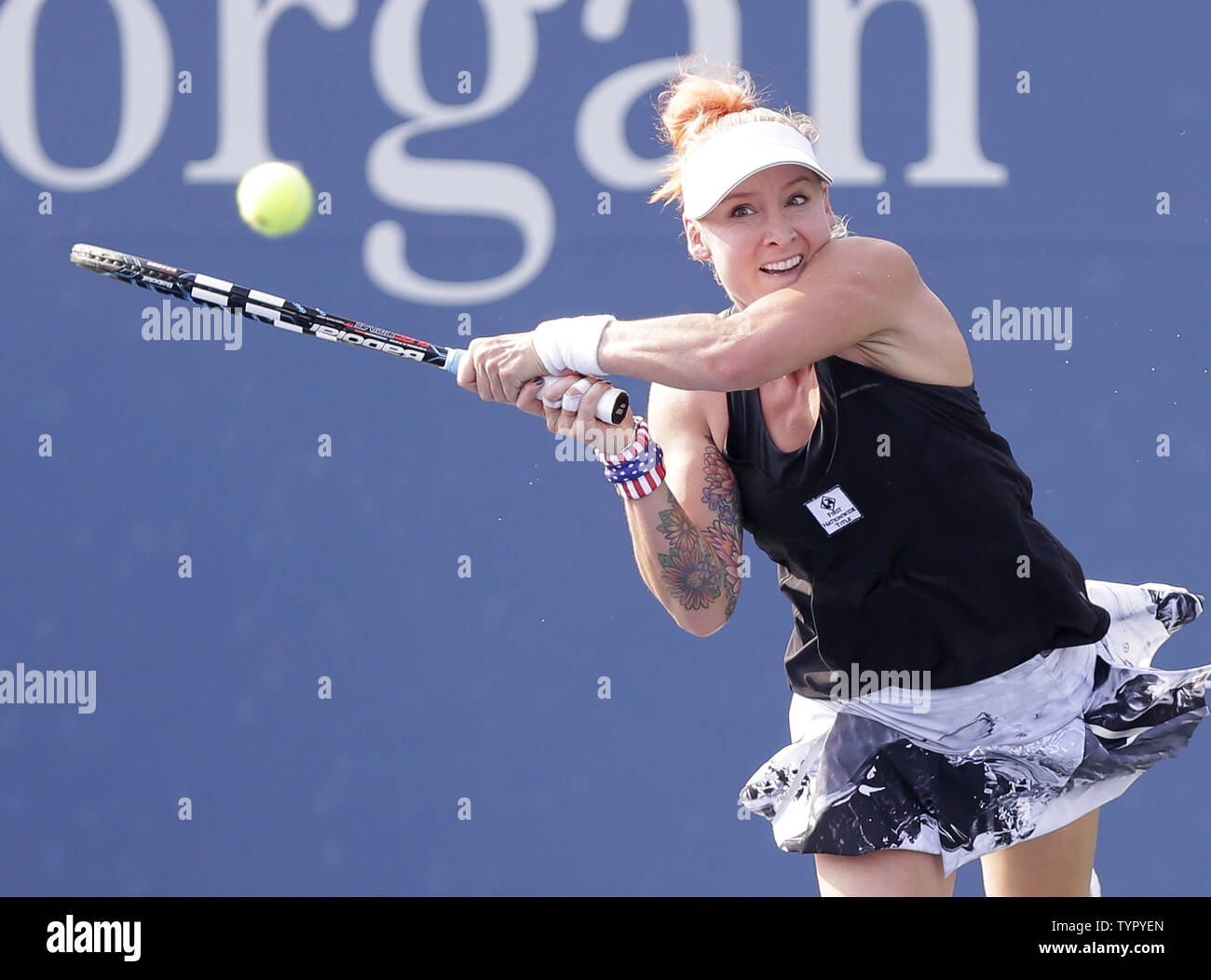 Bethanie Mattek-Sands returns a ball to Kateryna Kozlova of the Ukraine ...
