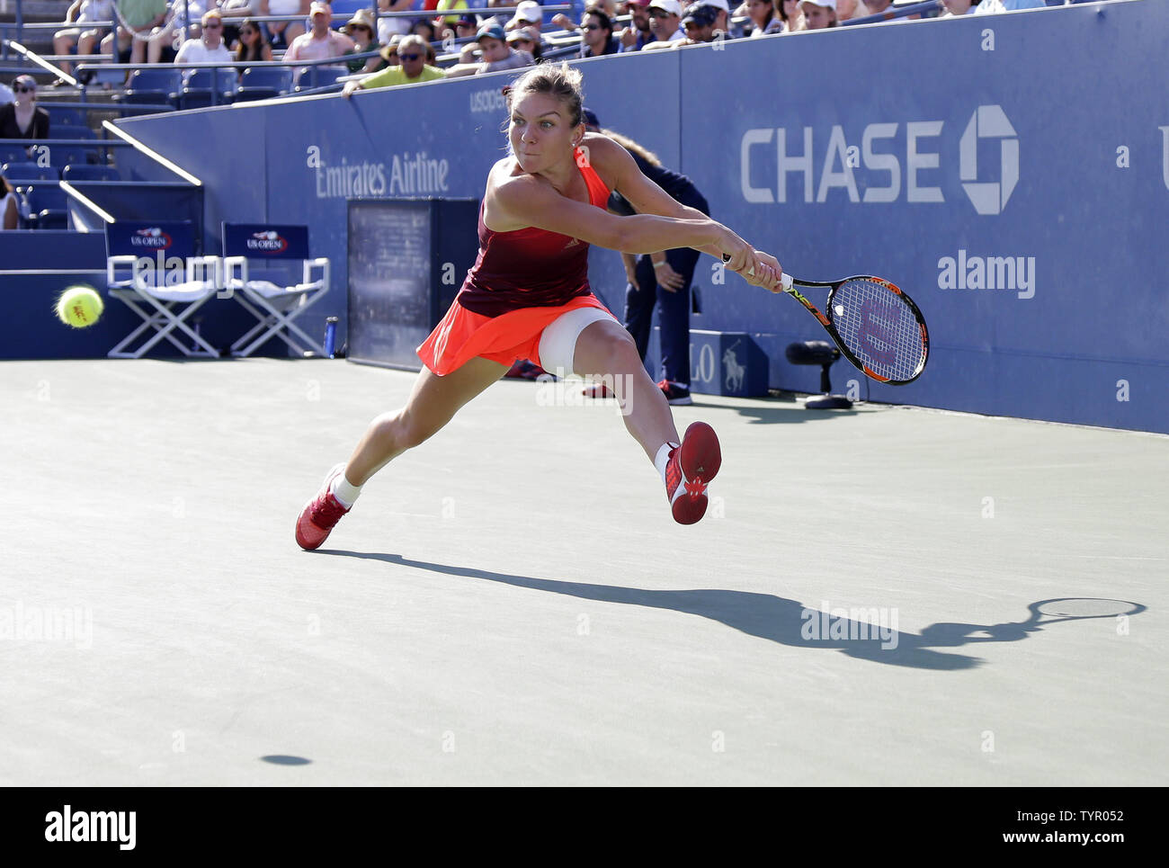 Simona Halep of Romania runs to hit a backhand to Sabine Lisicki of ...