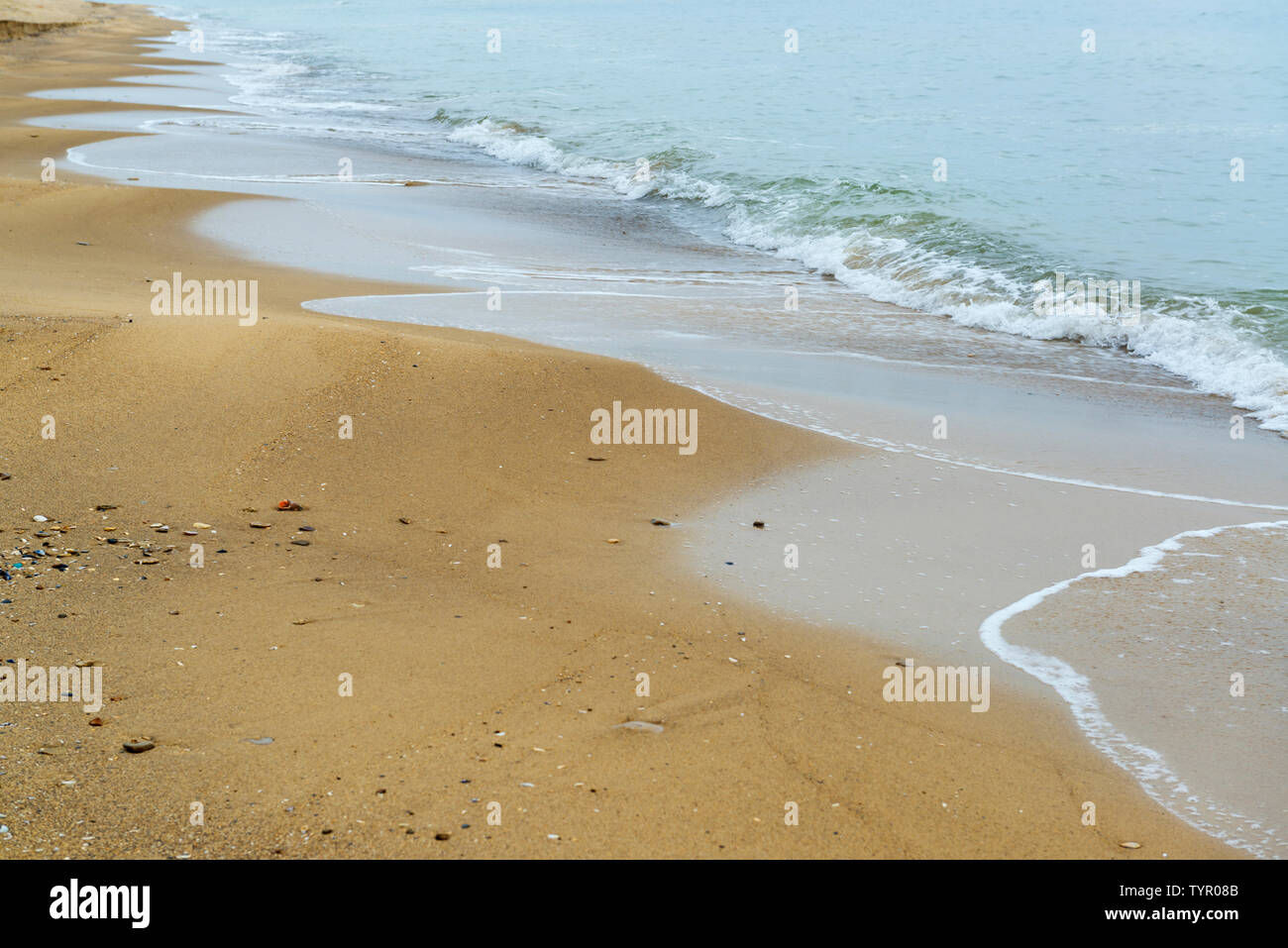 Curvy traces of sea waves on the beach sand Stock Photo - Alamy