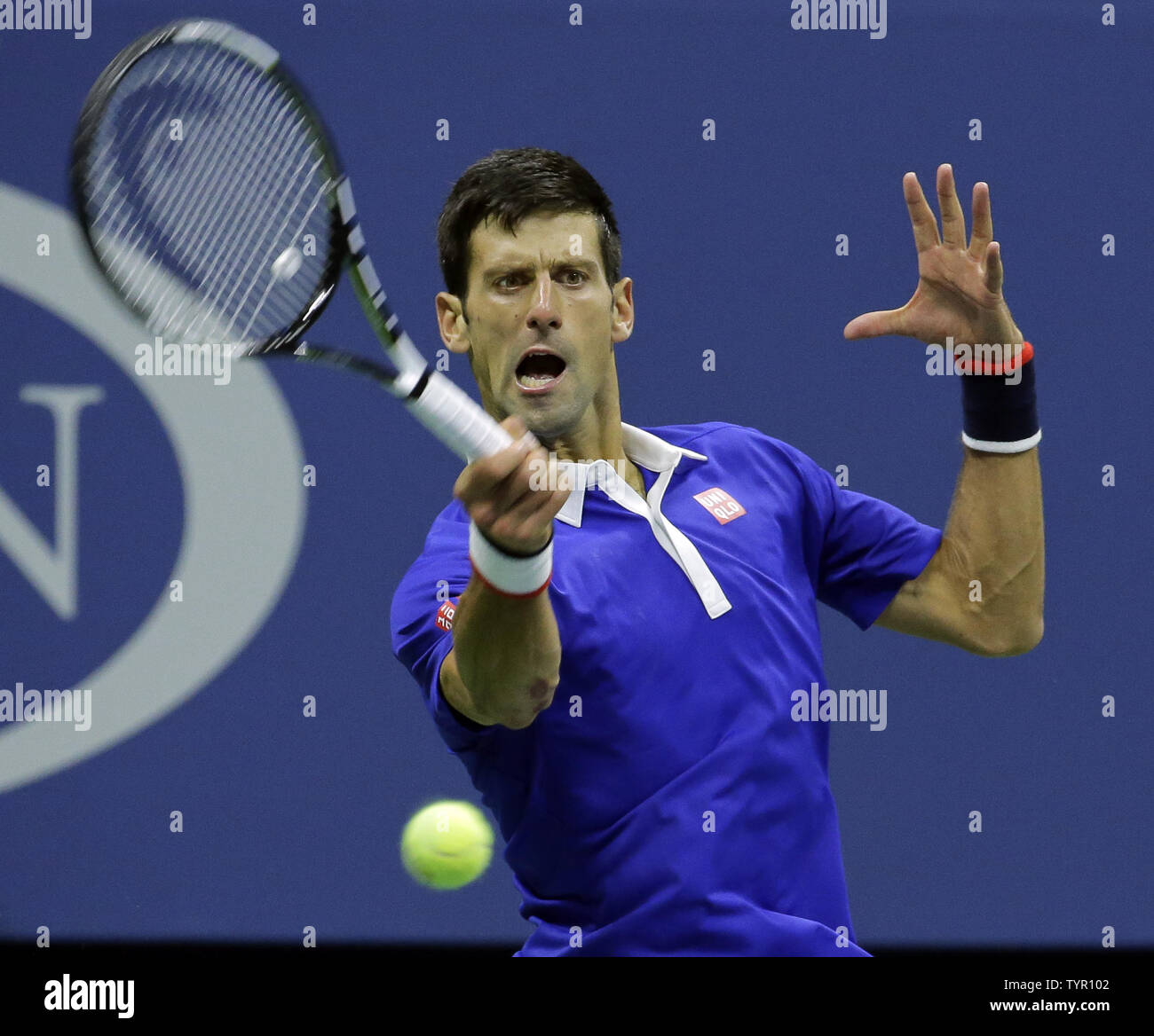 Novak Djokovic of Serbia returns a shot to Roger Federer of Switzerland ...