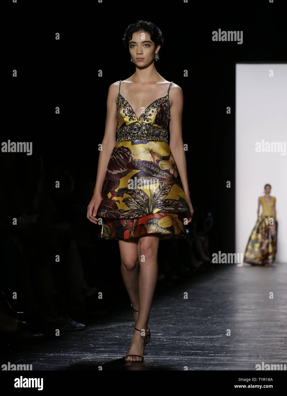 A model walks on the runway at the Dennis Basso Fashion Show at IMG New ...