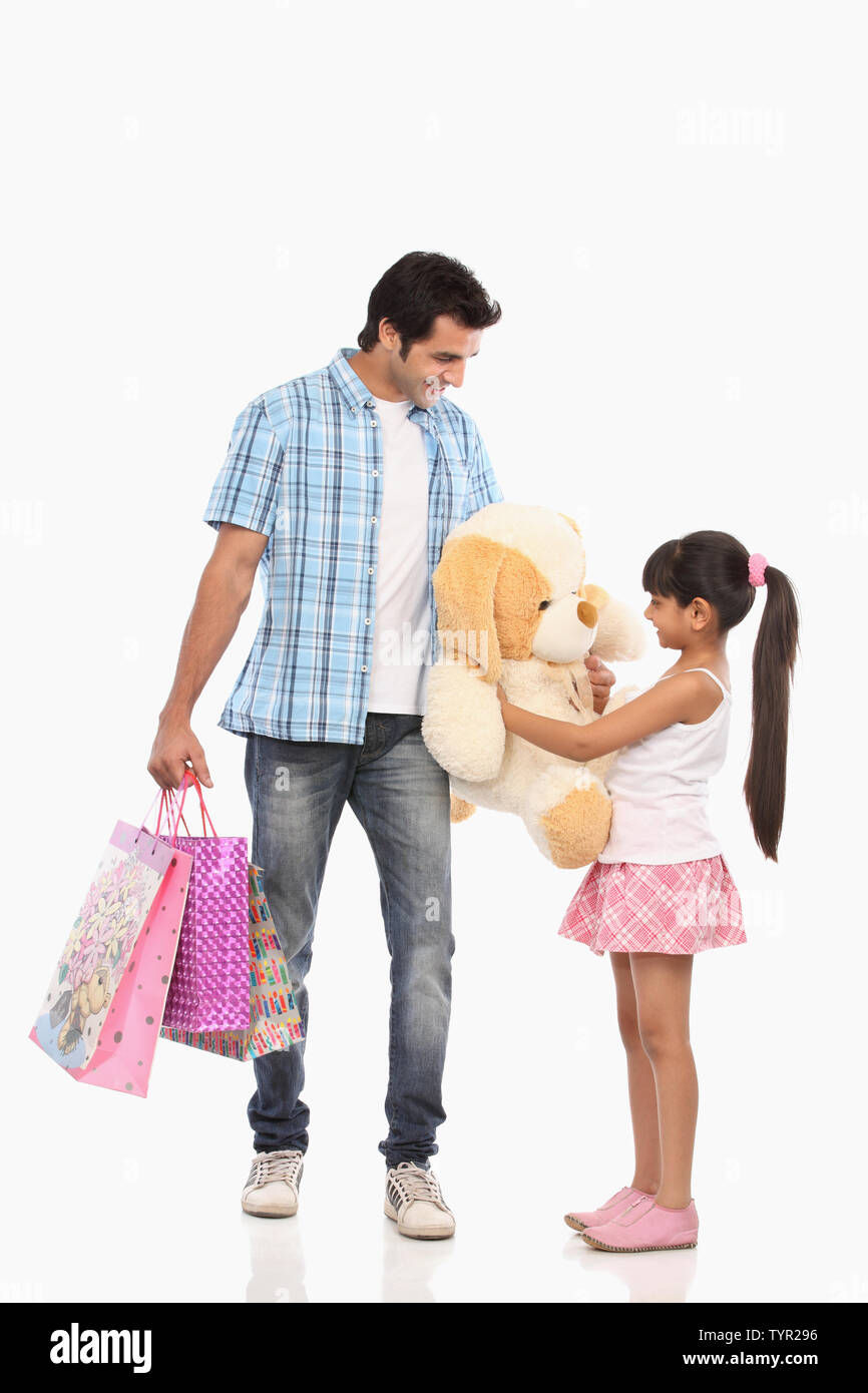 Man giving toy to his daughter Stock Photo - Alamy