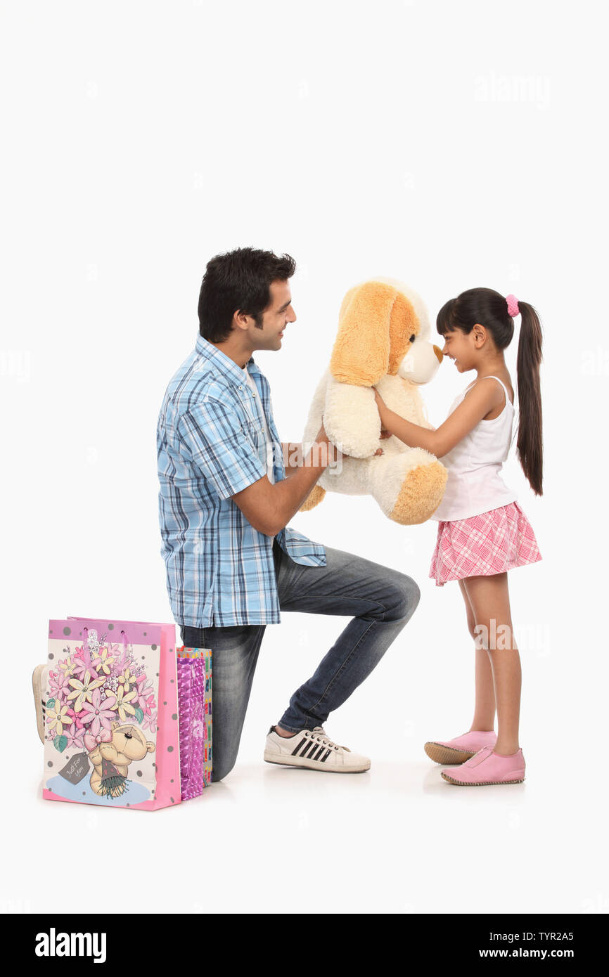 Man giving toy to his daughter Stock Photo - Alamy
