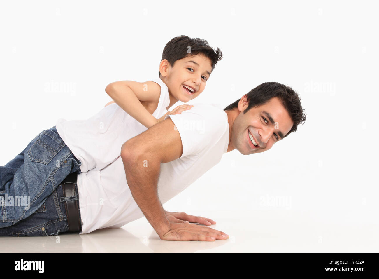 Father doing push-ups with son on his back Stock Photo - Alamy