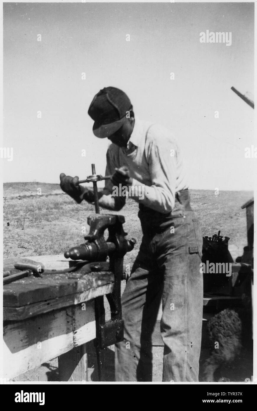 Workman using a vice Stock Photo - Alamy