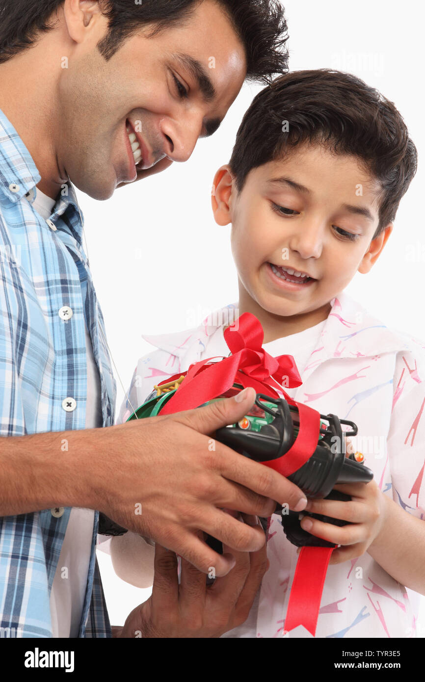 Man giving gift to his son Stock Photo - Alamy