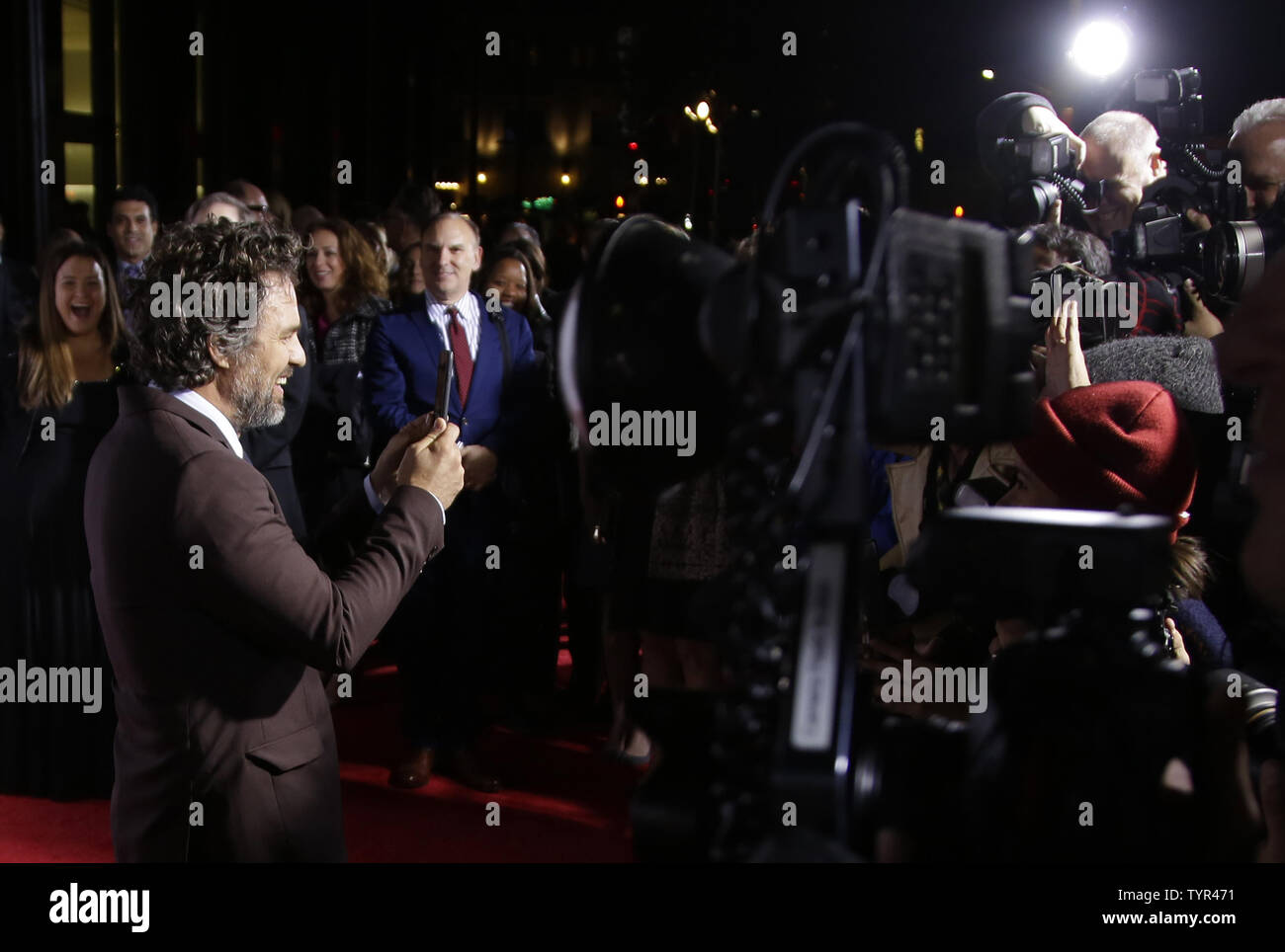 Mark Ruffalo takes photos of the photographers when he arrives on the ...