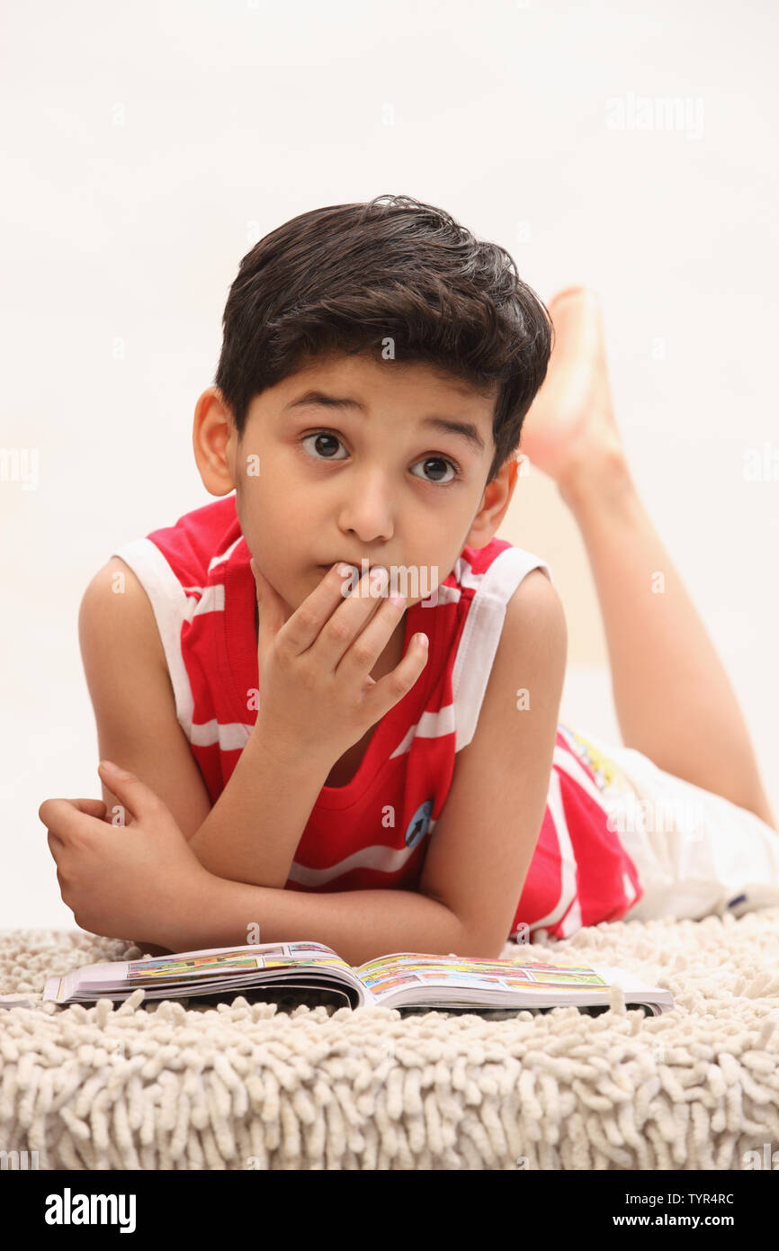 Boy reading a book Stock Photo - Alamy