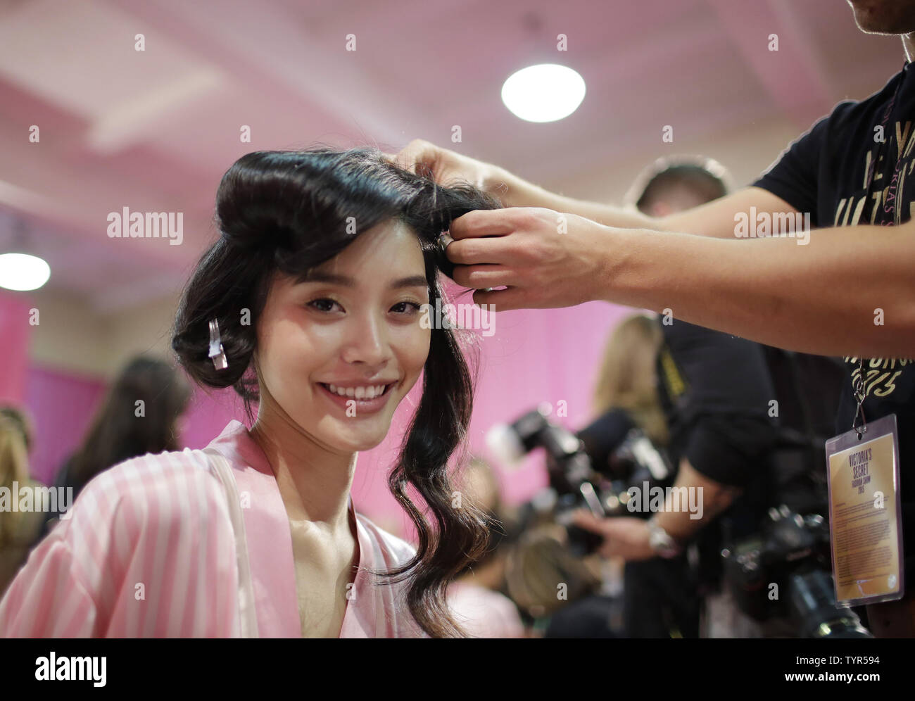 Ming Xi sit backstage for hair and makeup before the Victoria's Secret ...