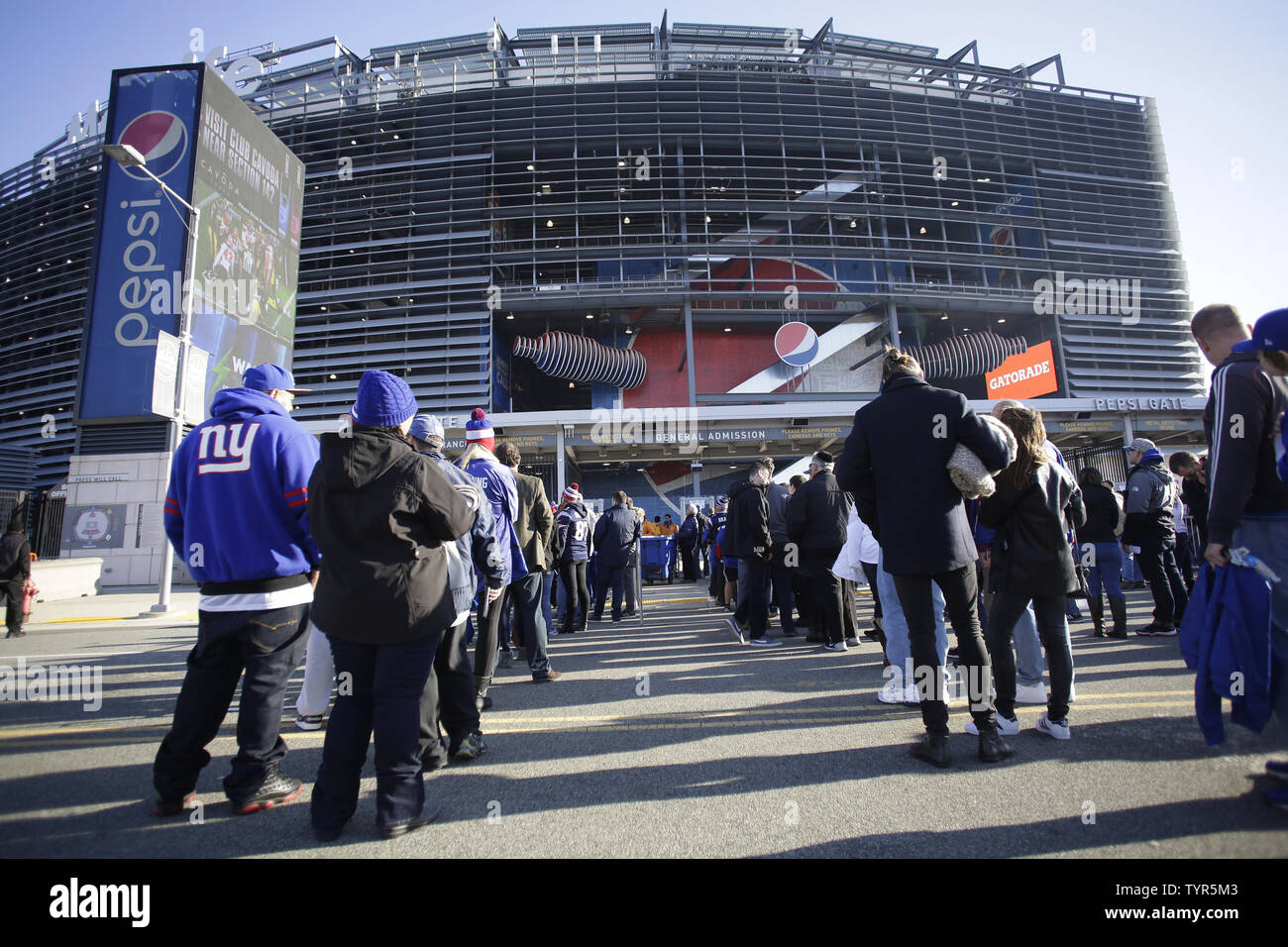 Fans go through a security checkpoint at the gates before the New York ...