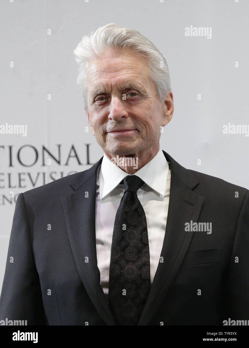 Presenter Michael Douglas stands on the stage in the pressroom at the ...