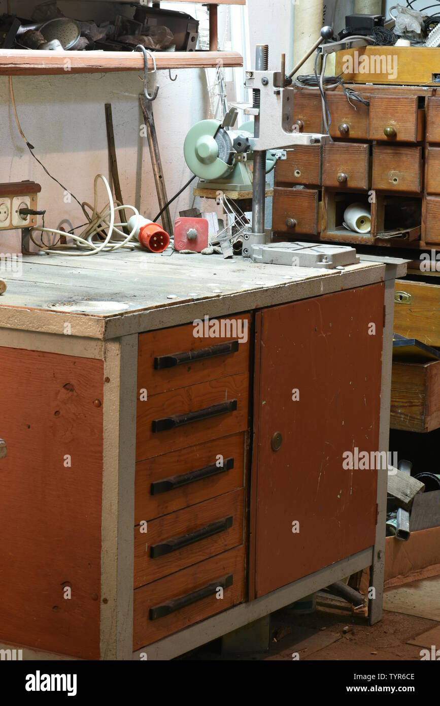 Hand tools on the table and shelf in messy home workshop Stock Photo ...