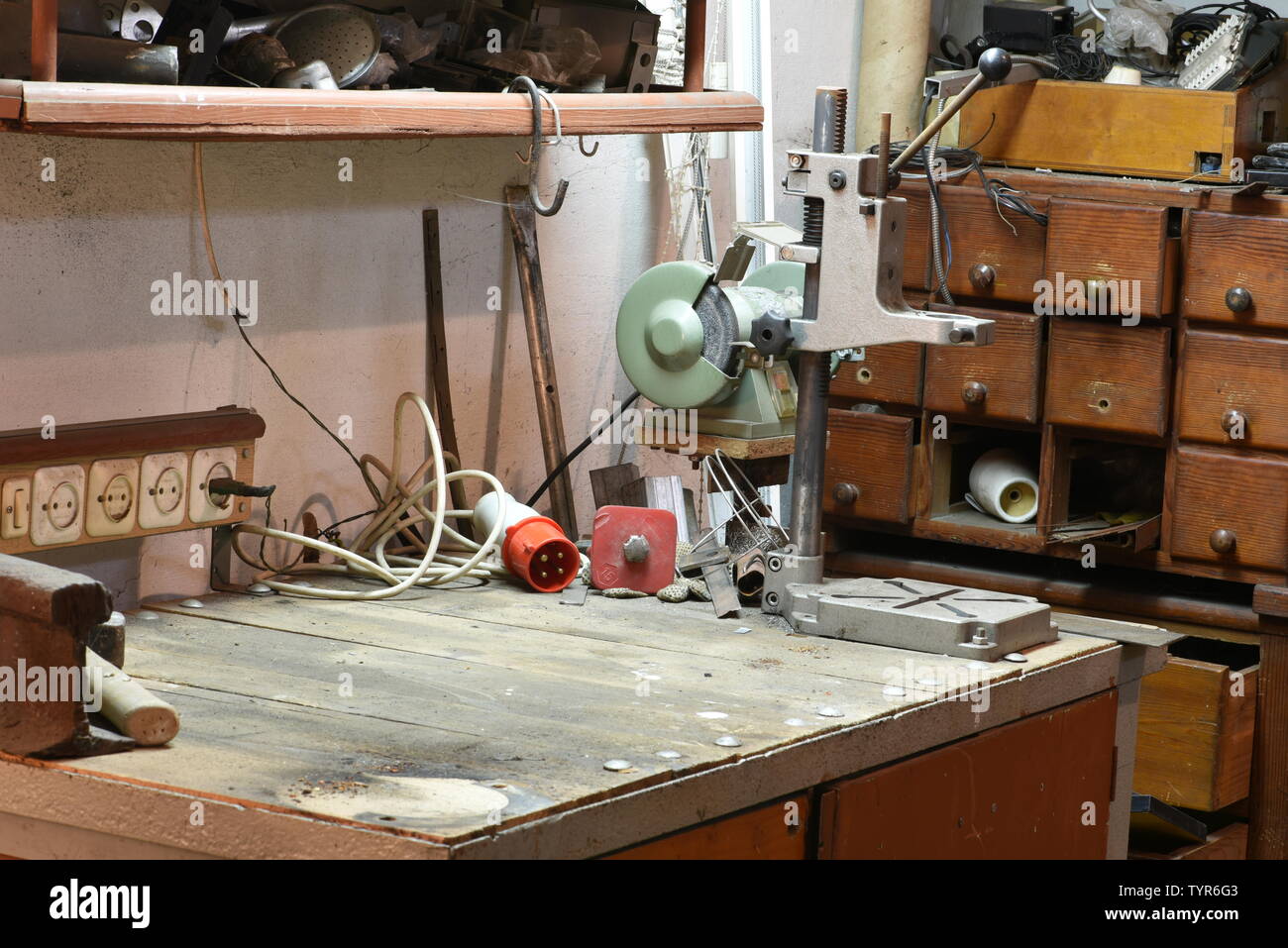 Hand tools on the table and shelf in messy home workshop Stock Photo ...