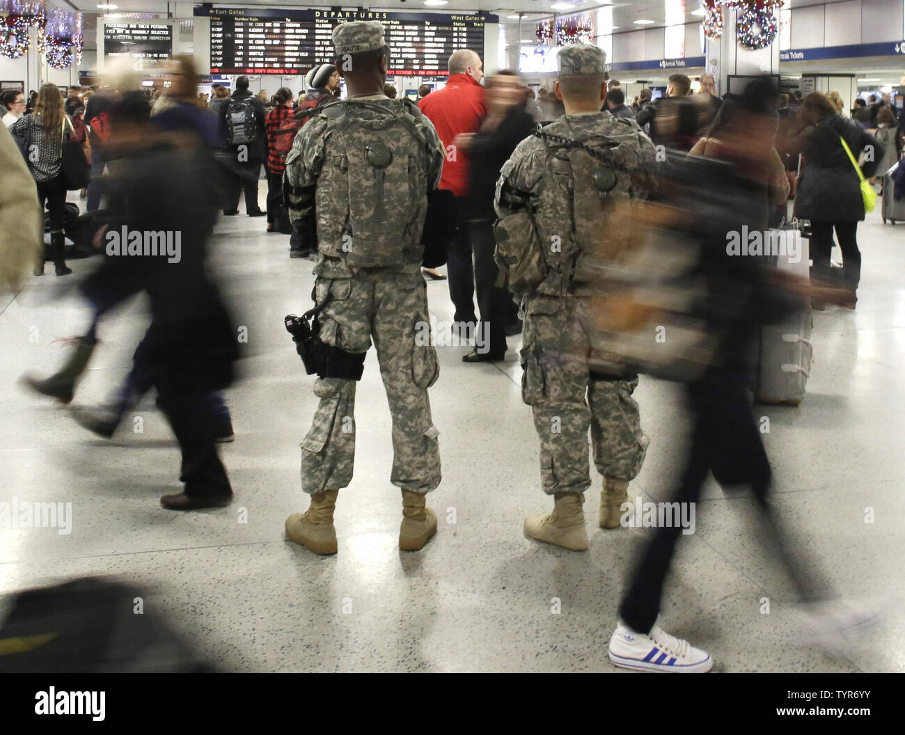 Two U.S. Army National Guard men stand guard among travelers at Penn ...