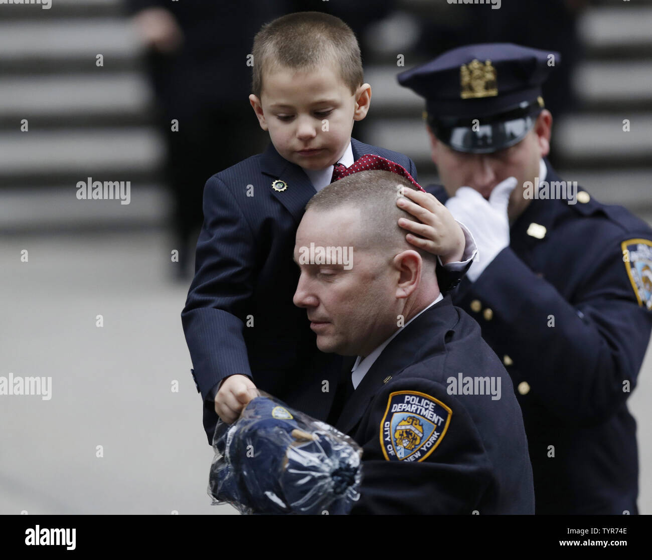 Detective Joseph Lemm's 4-year-old son is carried away holding an NYPD ...