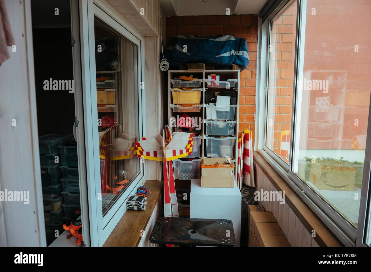 Wardrobe with things on the balcony, Red bricks on the back wall Stock ...