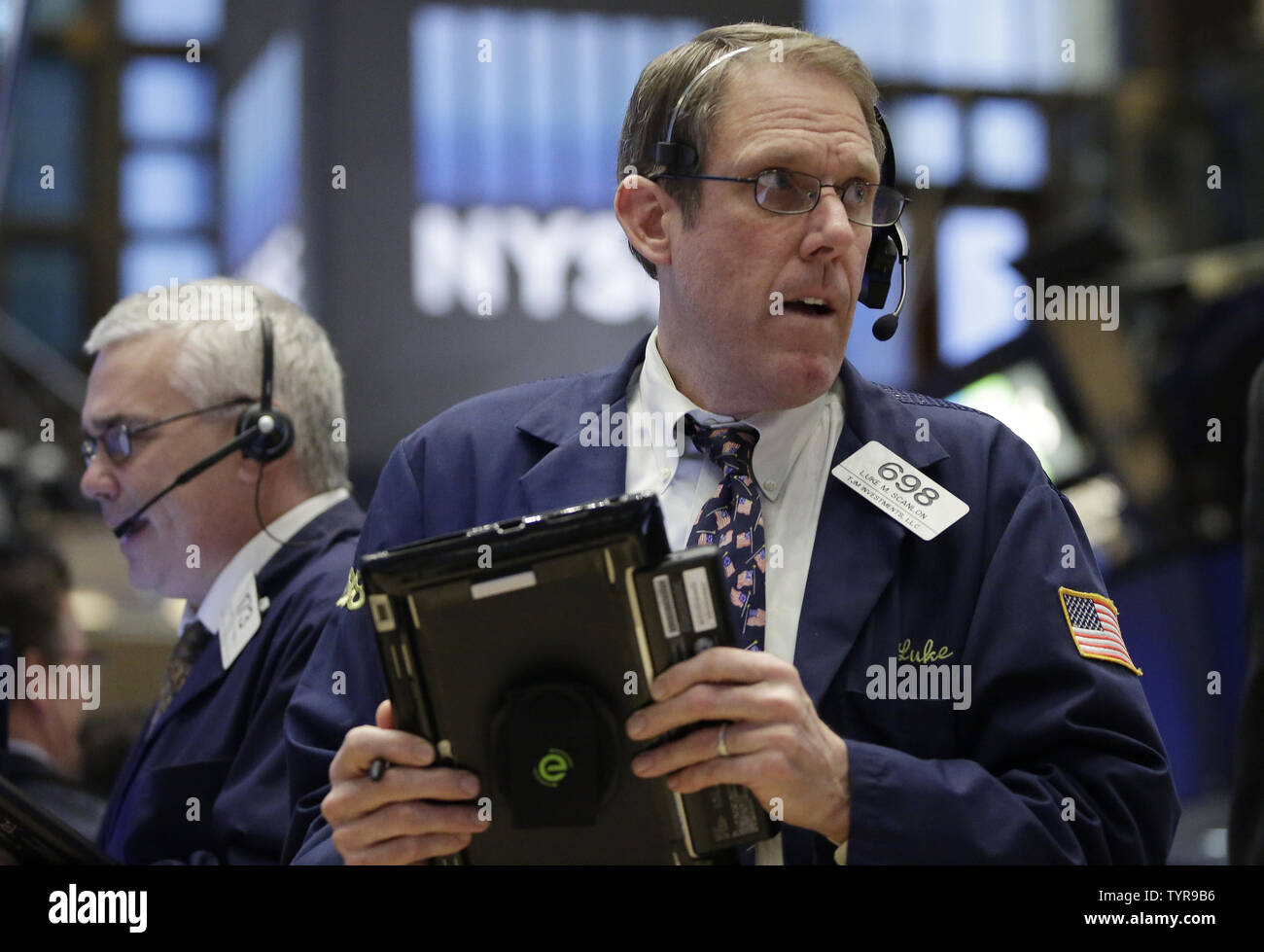 Traders work on the floor of the NYSE at the opening bell at the New ...