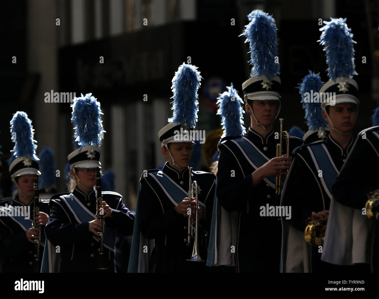 A marching band moves down the parade route at the St. Patrick's Day ...