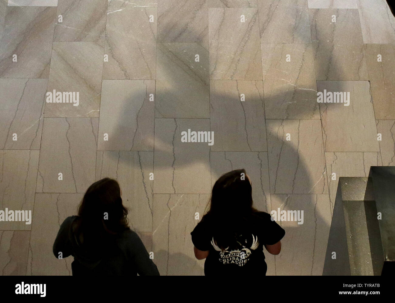 the shadow of a Greek bronze statue of a man is cast on the floor of ...