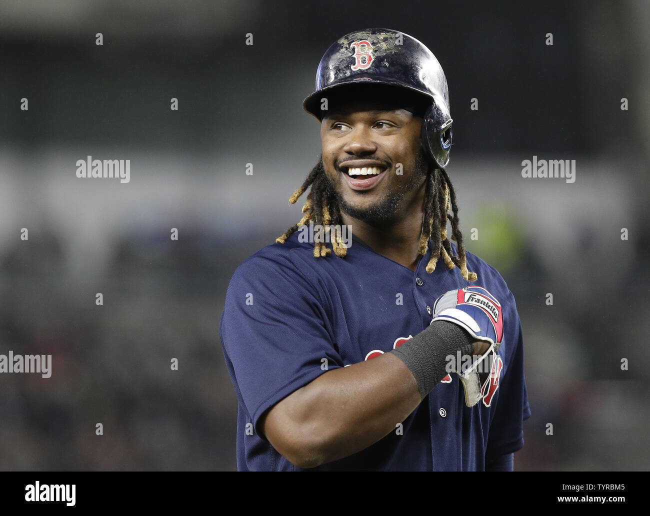 Boston Red Sox Hanley Ramirez smiles standing on third base against the ...