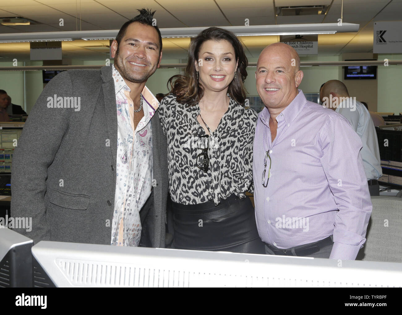 Johnny Damon, Bridget Moynahan and BTIG Co-Founder Steven Starker stand ...