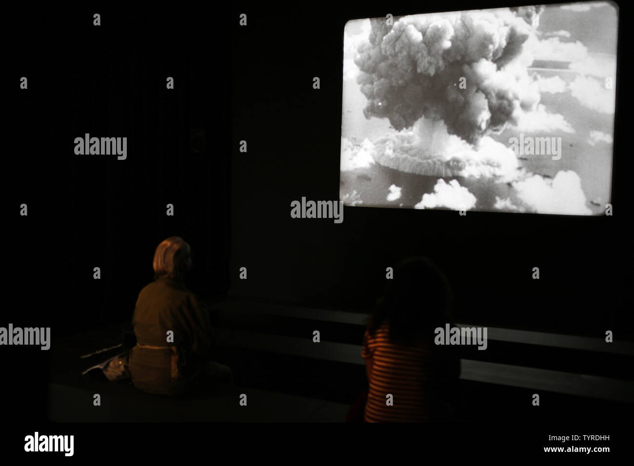 Two women watch an art film at press preview of the 'Bruce Conner: It's ...