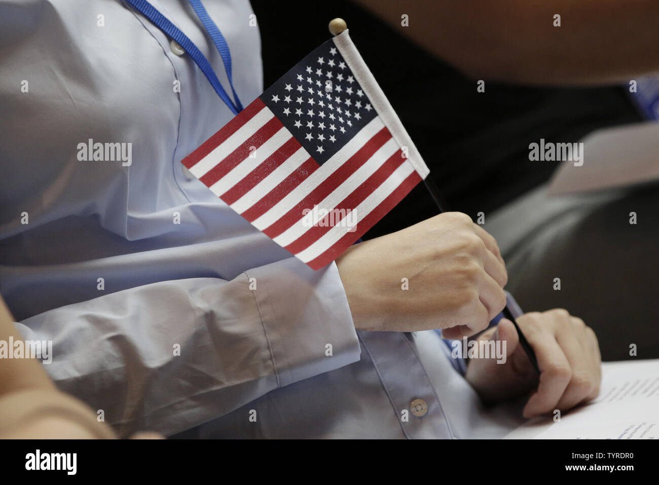 New Citizens of the United States of America hold American Flags when U ...