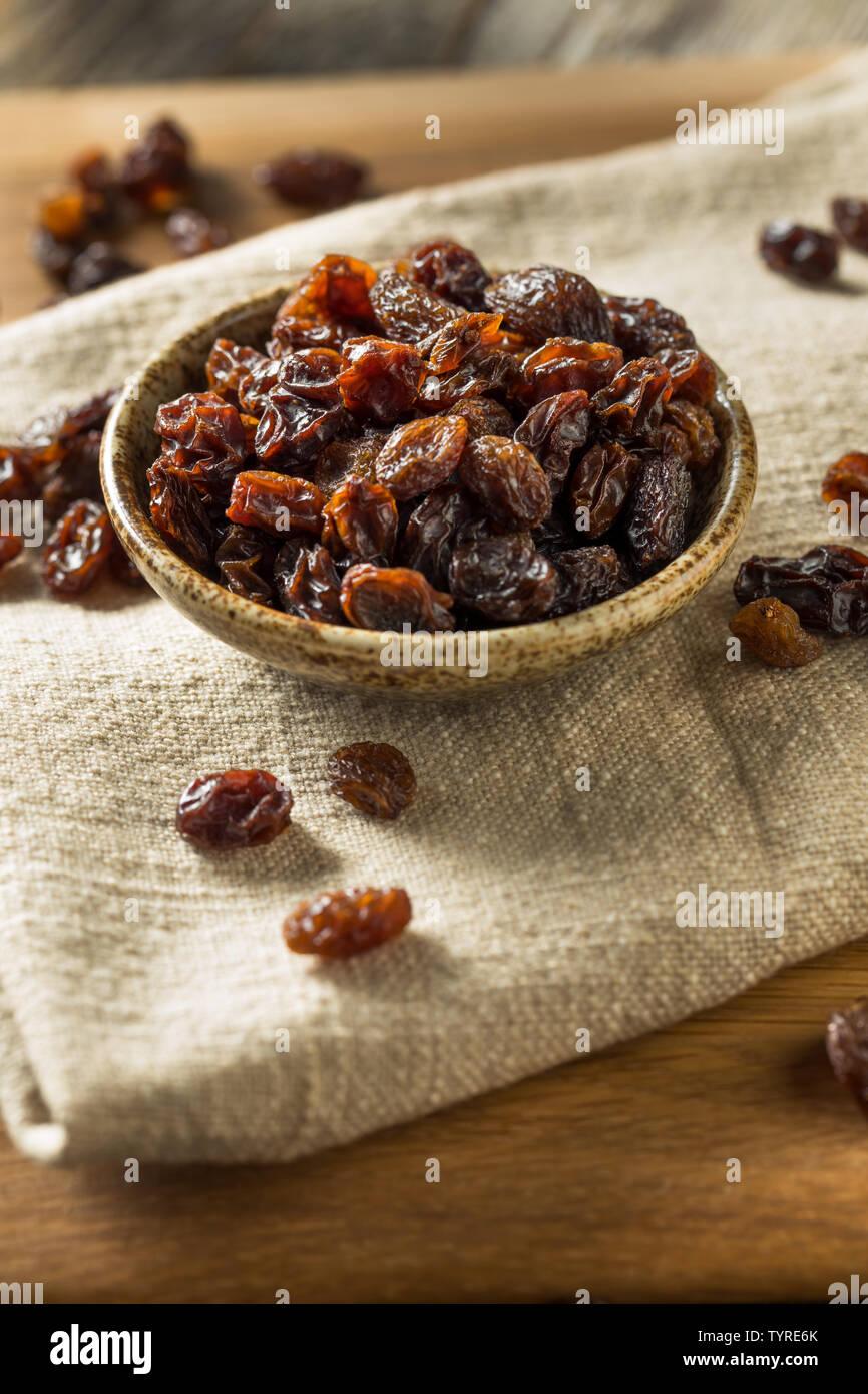Organic Dried Brown Raisins in a Bowl Stock Photo - Alamy
