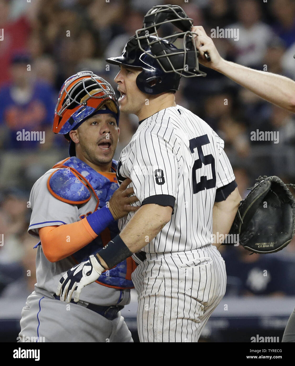 New York Yankees Mark Teixeira reacts and is held back by New York Mets ...