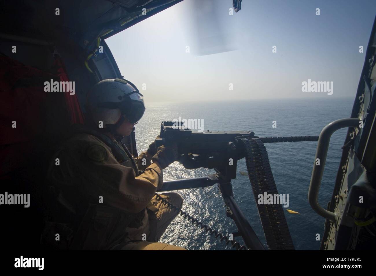 OF OMAN (Nov. 22, 2016) Petty Officer 3rd Class Ryan Stockman fires the ...