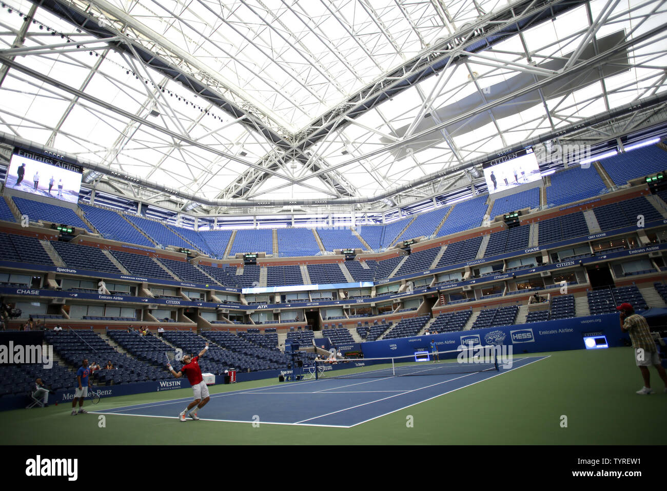 Players practice with the retractable roof closed in Arthur Ashe ...