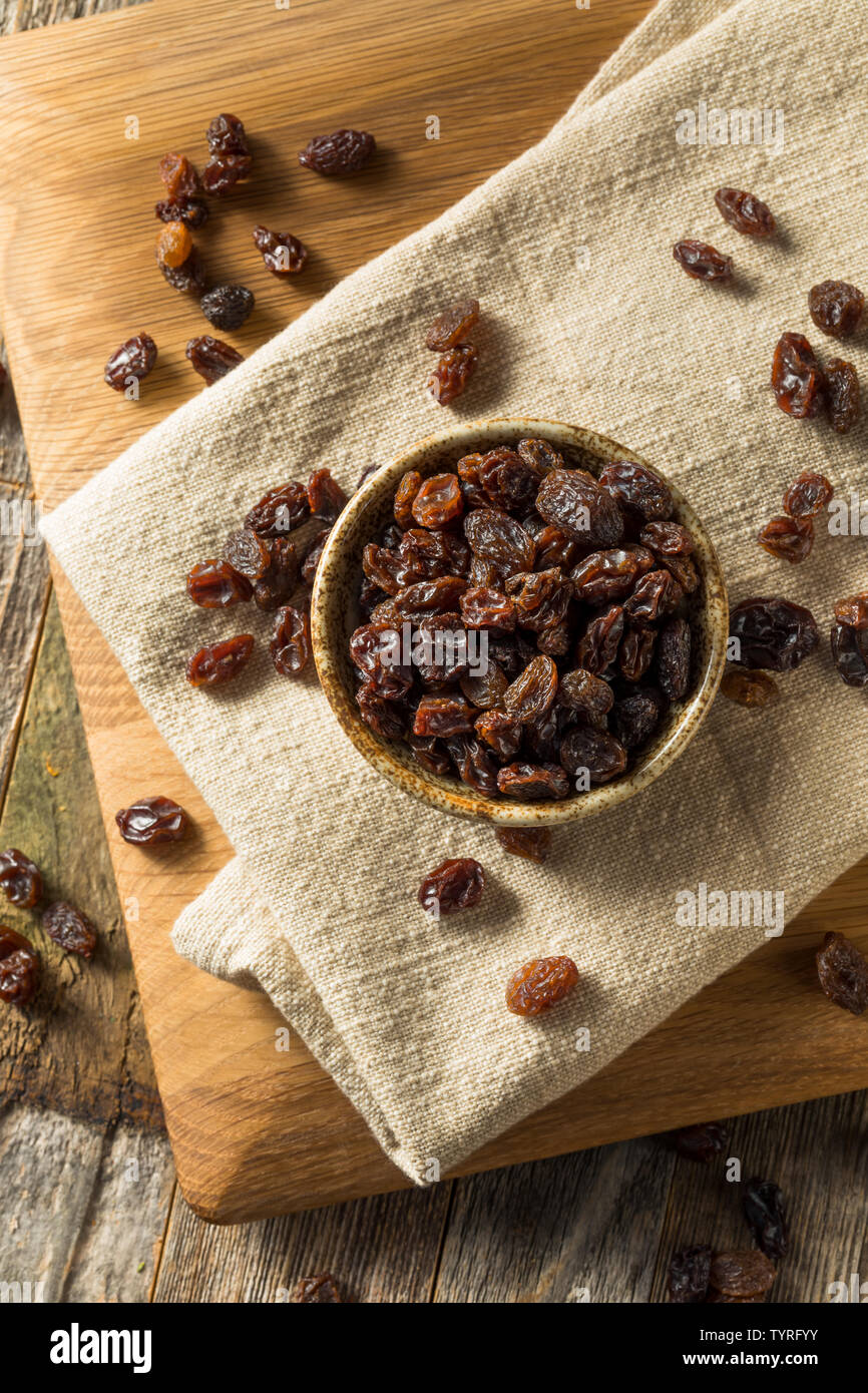 Organic Dried Brown Raisins in a Bowl Stock Photo - Alamy