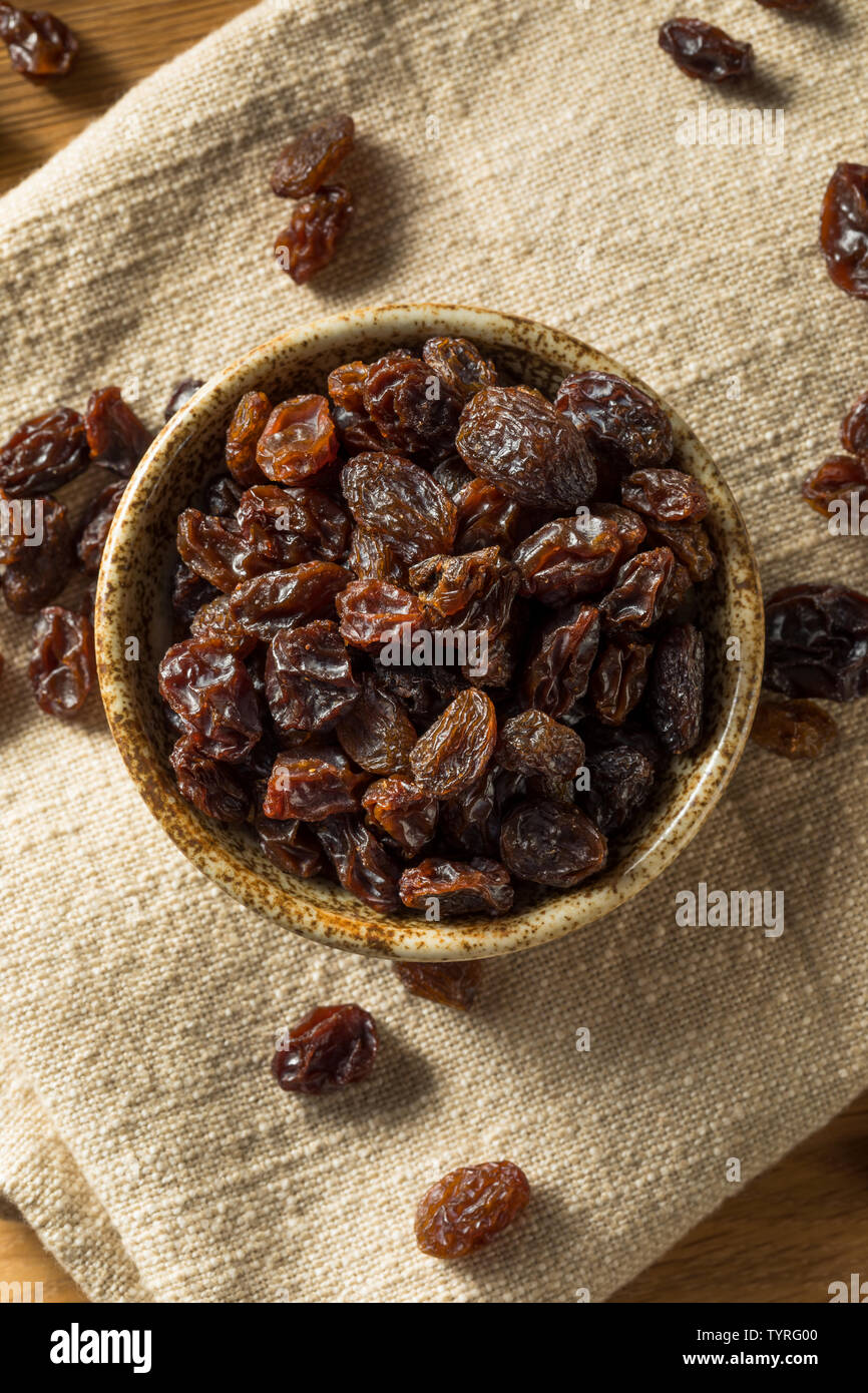 Organic Dried Brown Raisins in a Bowl Stock Photo - Alamy