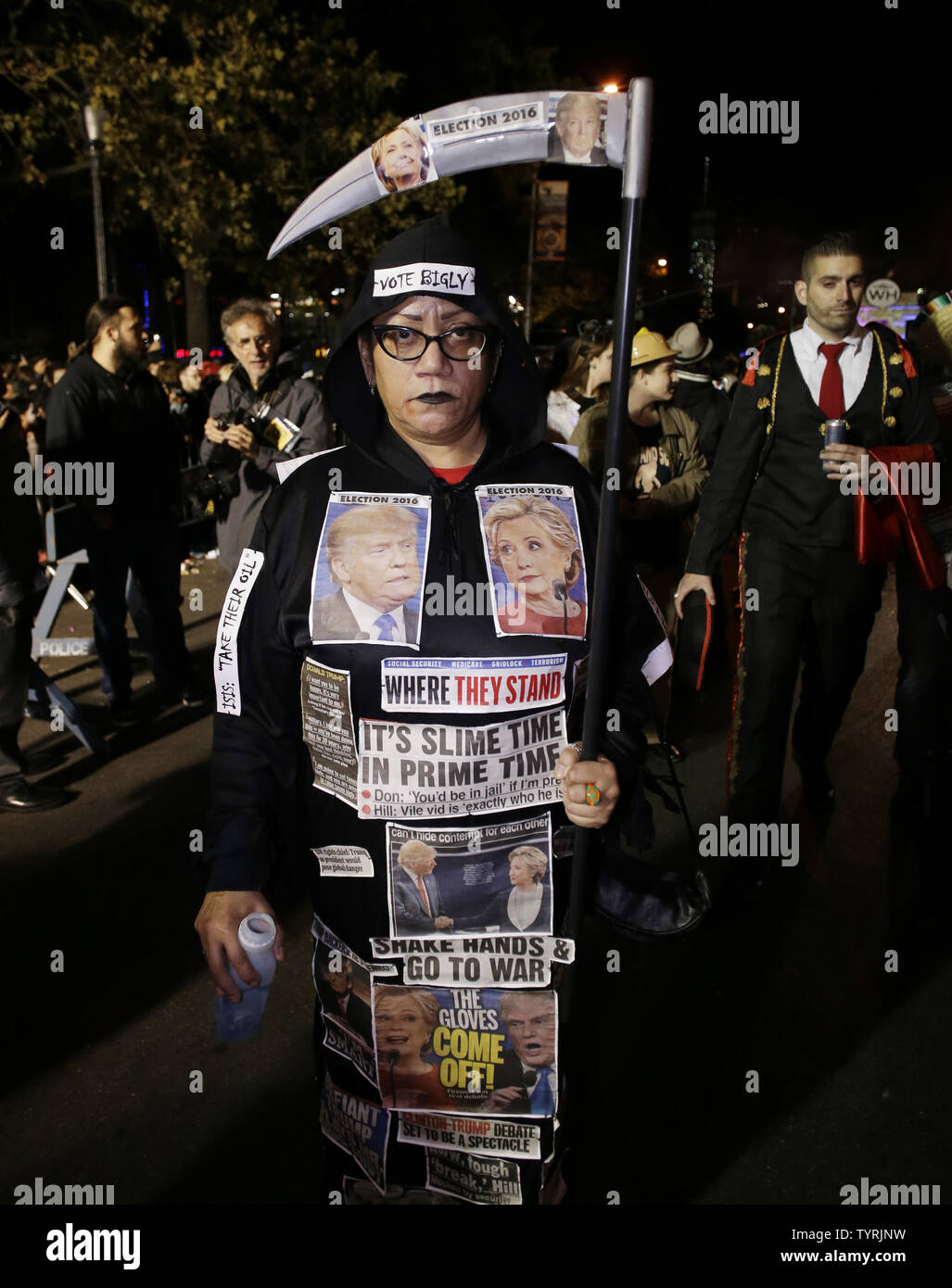 A woman dressed in election headlines and photos marches up Sixth ...