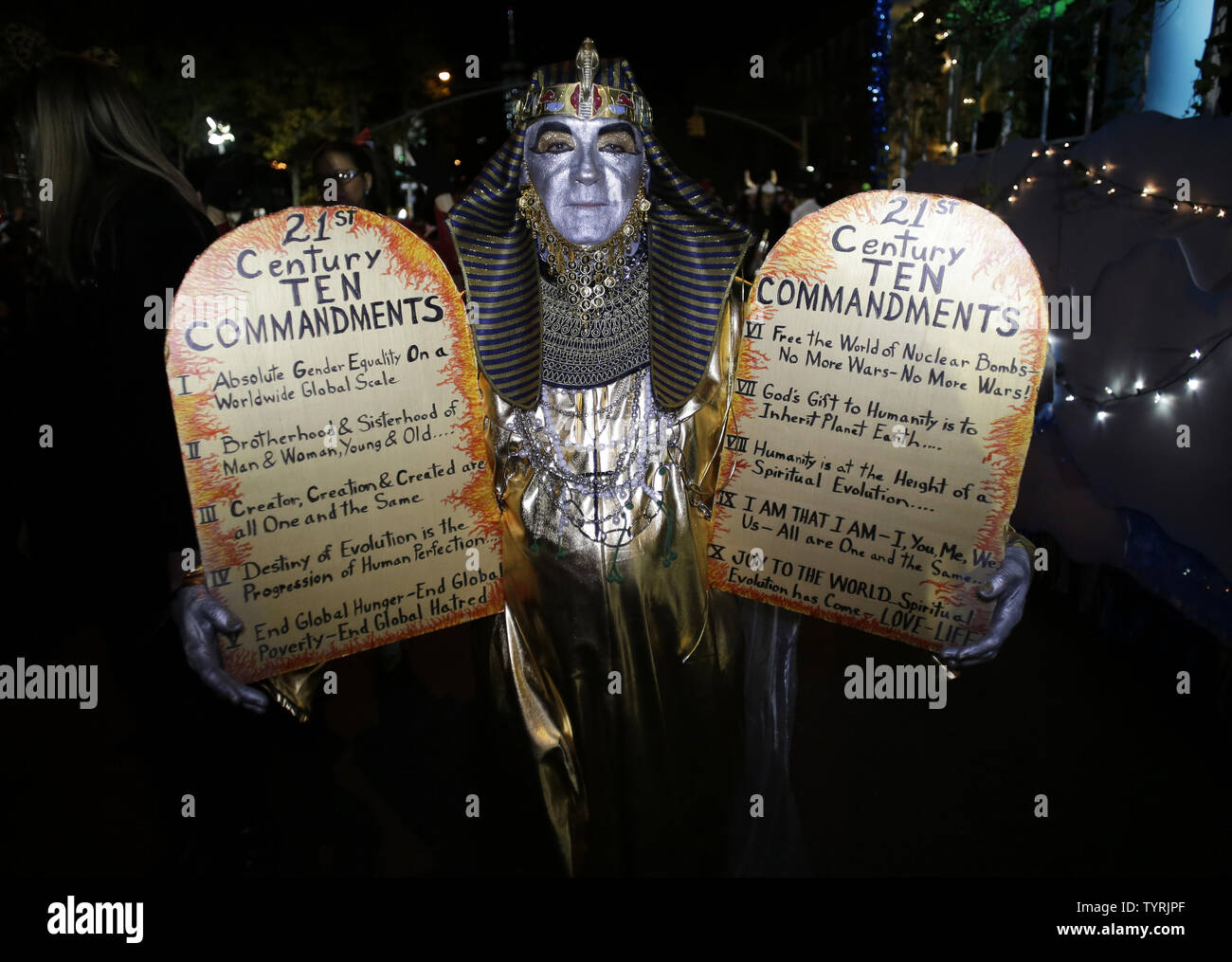A participant holds up the 21st Century Ten Commandments as he marches ...