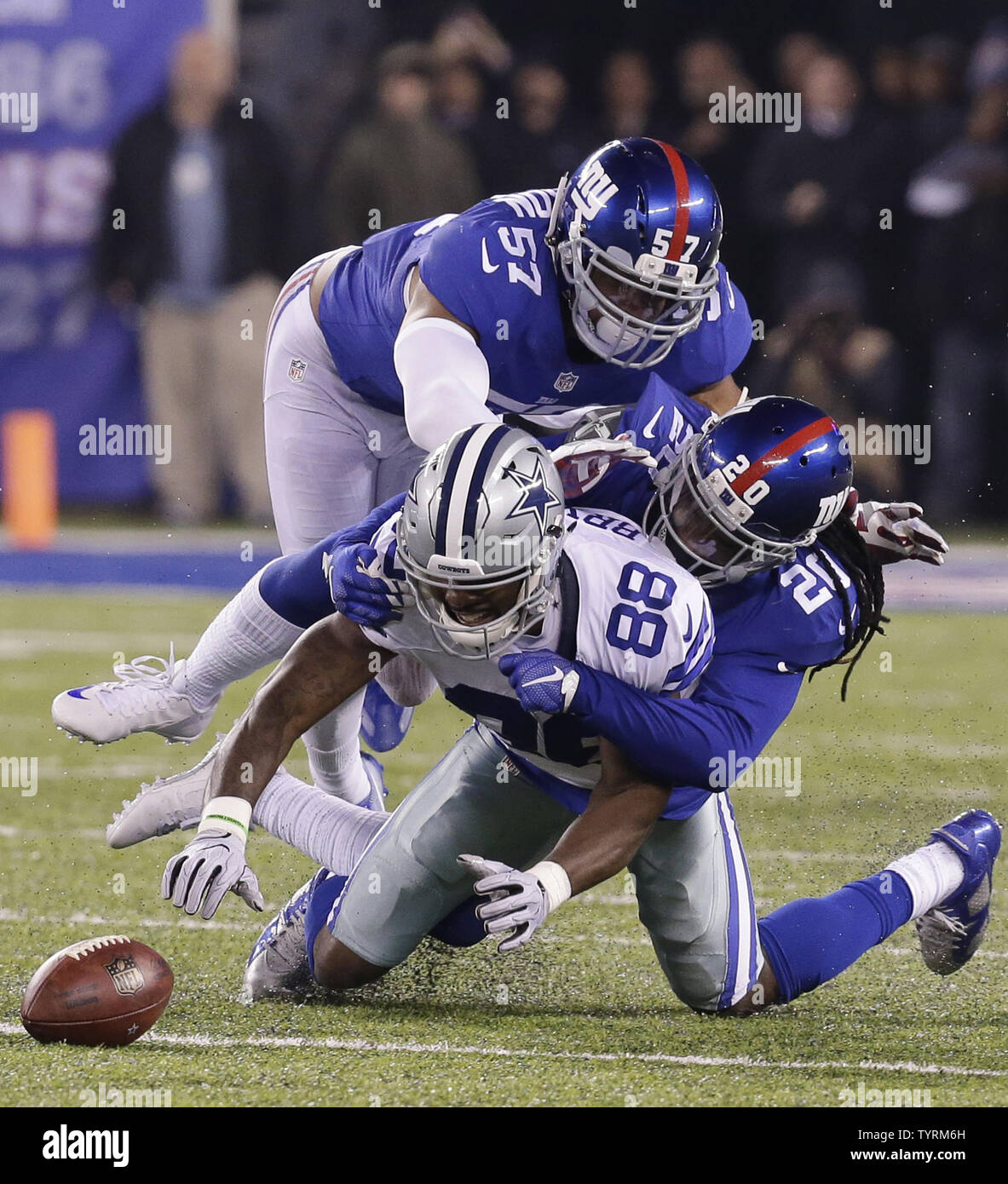 New York Giants Keenan Robinson stands behind Janice Jenkins who hits ...