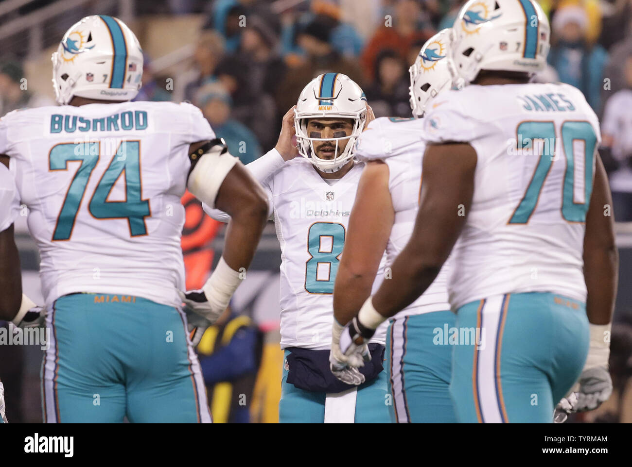 Miami Dolphin Matt Moore stands in the huddle in the first half against ...