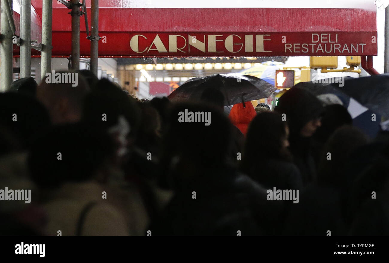 Two long lines of customers wait to enter Carnegie Deli Restaurant on ...