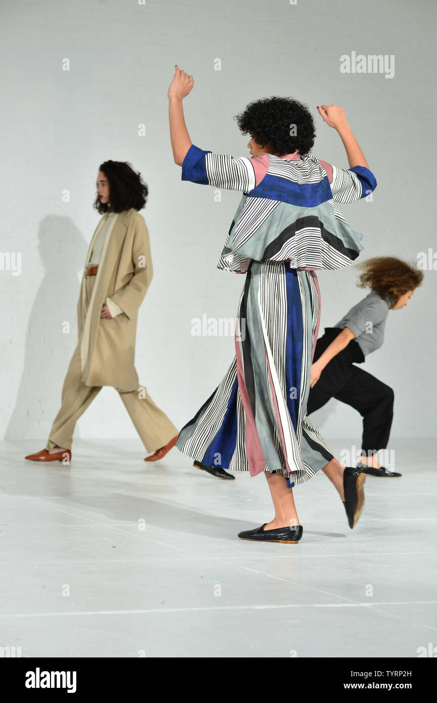 A model walks on the runway as dancers perform at the Mara Hoffman ...