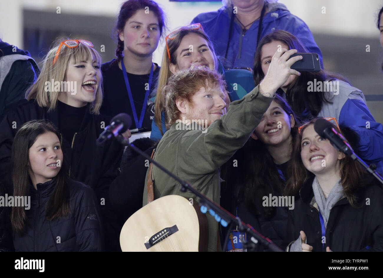 Ed Sheeran takes a selfie with fans on stage when he performs on the ...